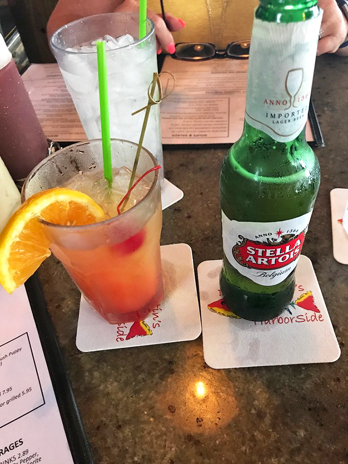 Vacation officially begins when the colorful drinks arrive. A cold Stella and a fruity cocktail—the perfect companions for seafood feasting.