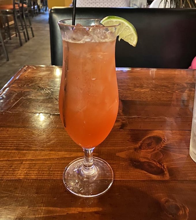 Cocktails at Carmi come with a side of sunshine. This peachy concoction with its lime garnish is summer in a glass.