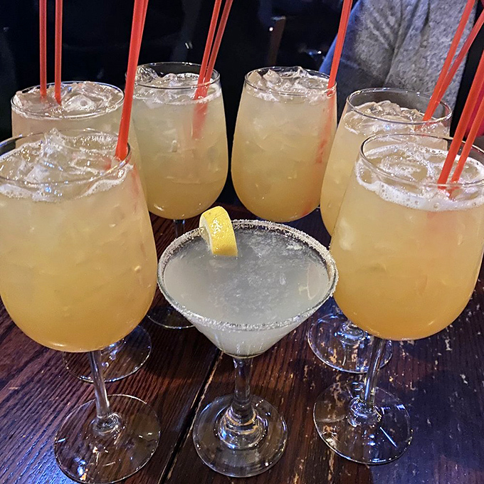 Cocktail hour done right. That margarita in the middle looks like it's trying to photobomb a family reunion of whiskey sours.