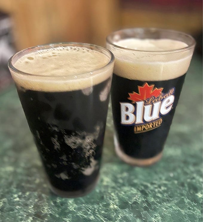 Two stouts standing at attention, their creamy heads like pillowy clouds atop glasses of liquid comfort. Beer this photogenic rarely disappoints the palate.