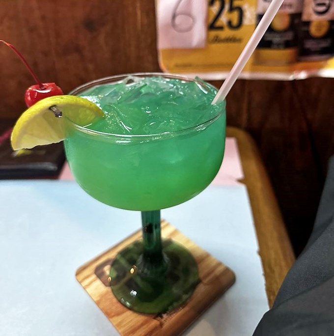 Electric blue cocktail that screams "vacation mode activated"&mdash;complete with the lime and cherry accessories it deserves.