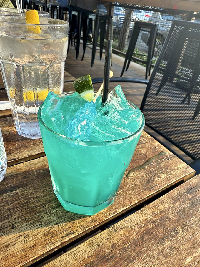 That electric blue cocktail isn't just a drink&mdash;it's a vacation in a glass, offering a momentary escape while you sit on the patio.