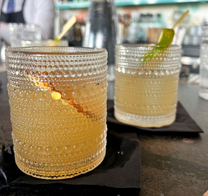 Textured glassware cradles golden cocktails that promise to make your evening sparkle. Tiny bubbles, big memories.