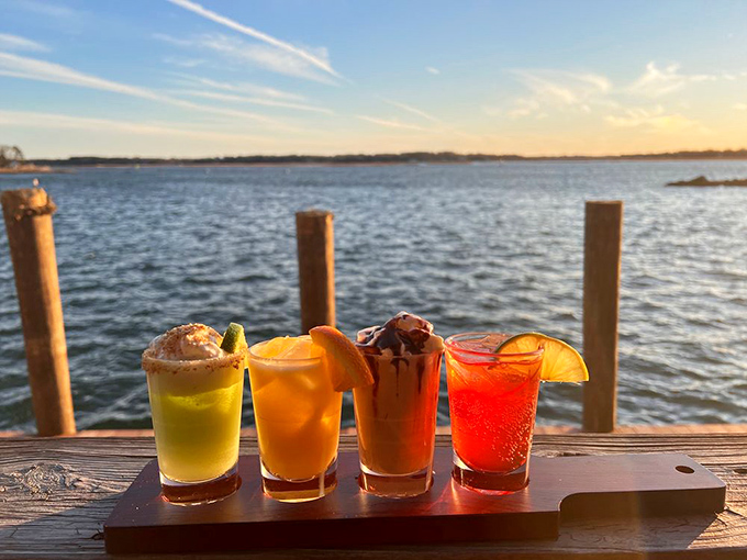 Sunset cocktails lined up like liquid jewels – proof that sometimes the best views come in glassware as well as panoramas.