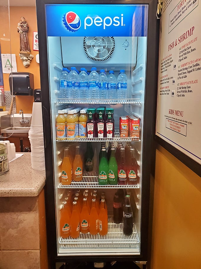 Mexican sodas and traditional beverages line up like colorful soldiers ready for flavor battle duty.