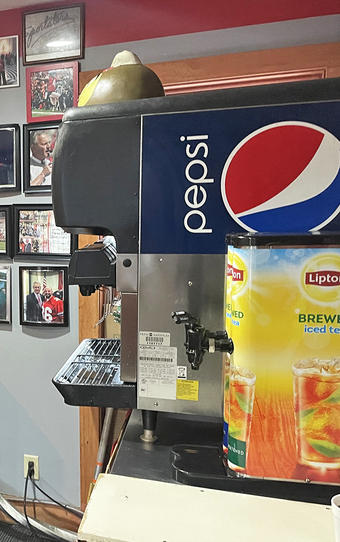Thirst-quenching central! The soda fountain stands ready to dispense liquid refreshment while Ohio sports legends look on from their framed perches.