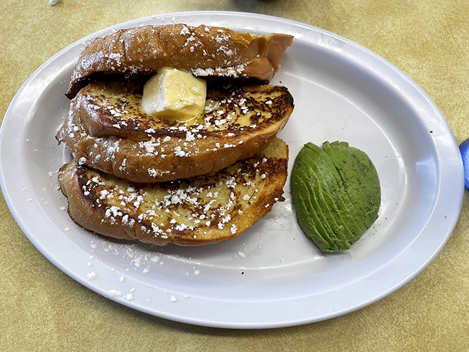 French toast that's dressed for success with a dusting of powdered sugar and a side of butter. Add that slice of avocado for a California twist on morning comfort.
