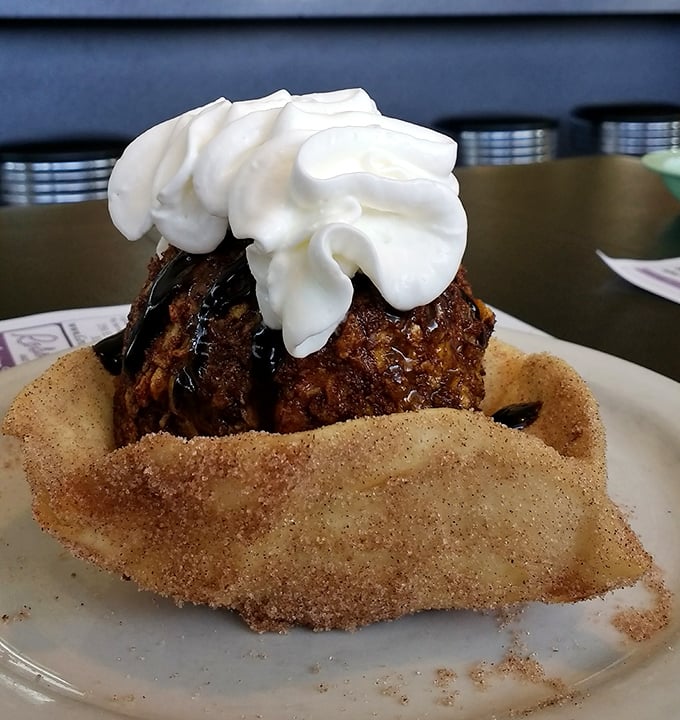 Fried ice cream nestled in a cinnamon-sugar shell like a sweet meteor that crashed into a sugar mine. Dessert physics at its finest.