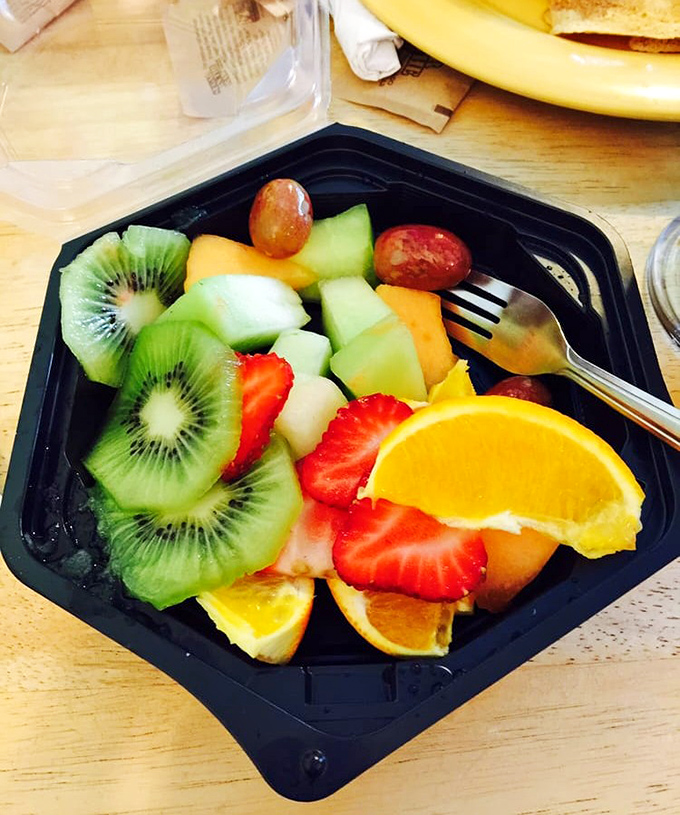 A fruit salad that actually looks like someone cared, with kiwi slices arranged like green poker chips in a game where everyone wins.