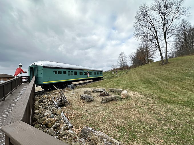 A historic Pullman car rests near the bobblehead, offering a glimpse into America's golden age of rail travel.