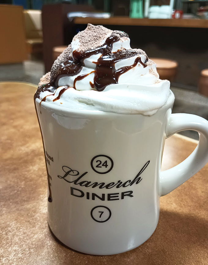 Hot chocolate crowned with a mountain of whipped cream and chocolate drizzle. Served in the diner's signature mug&mdash;a souvenir you can't take home.