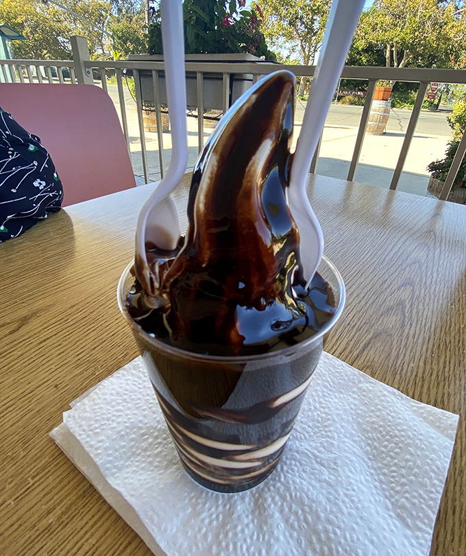 This hot fudge sundae isn't just dessert; it's a chocolate volcano erupting with childhood memories and grown-up indulgence.