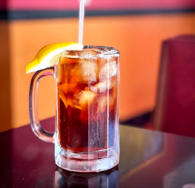 The humble iced tea, served in a frosty mug with a lemon wedge, becomes the perfect companion to breakfast indulgence.