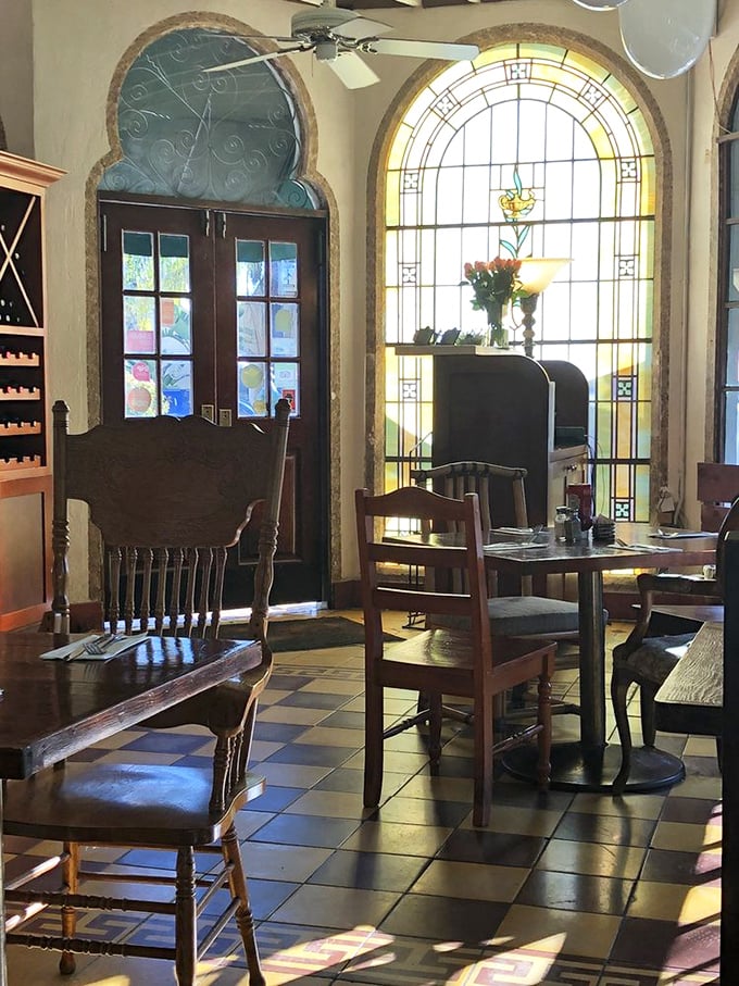 Stained glass windows bathe the dining room in golden light, turning your Tuesday breakfast into a quasi-religious experience.