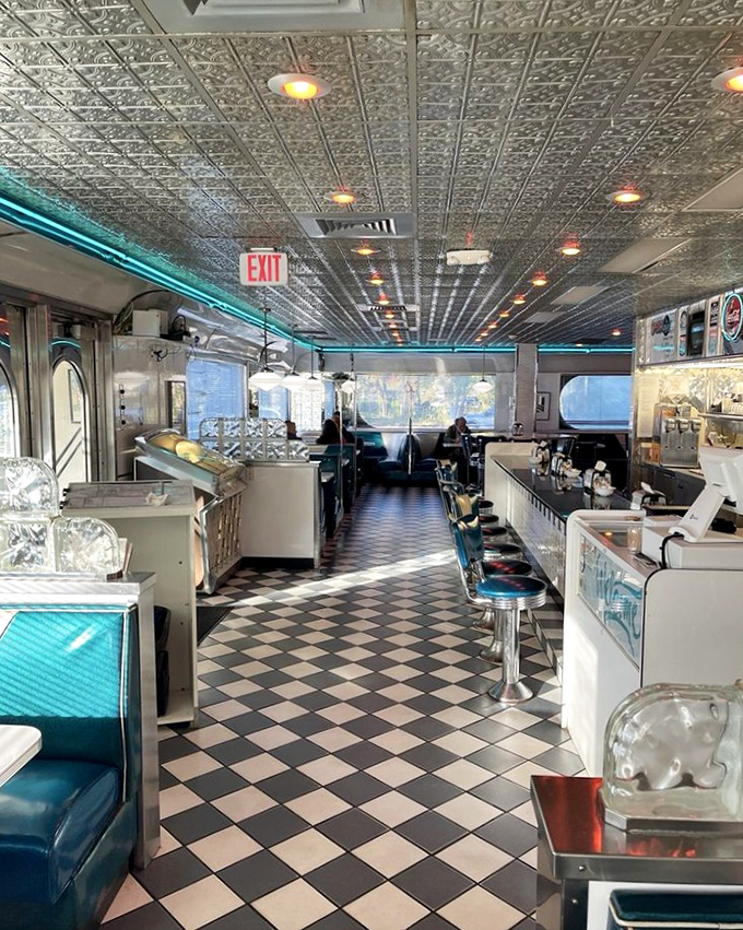 The counter stretches like a chrome runway where breakfast dreams take flight every single morning.