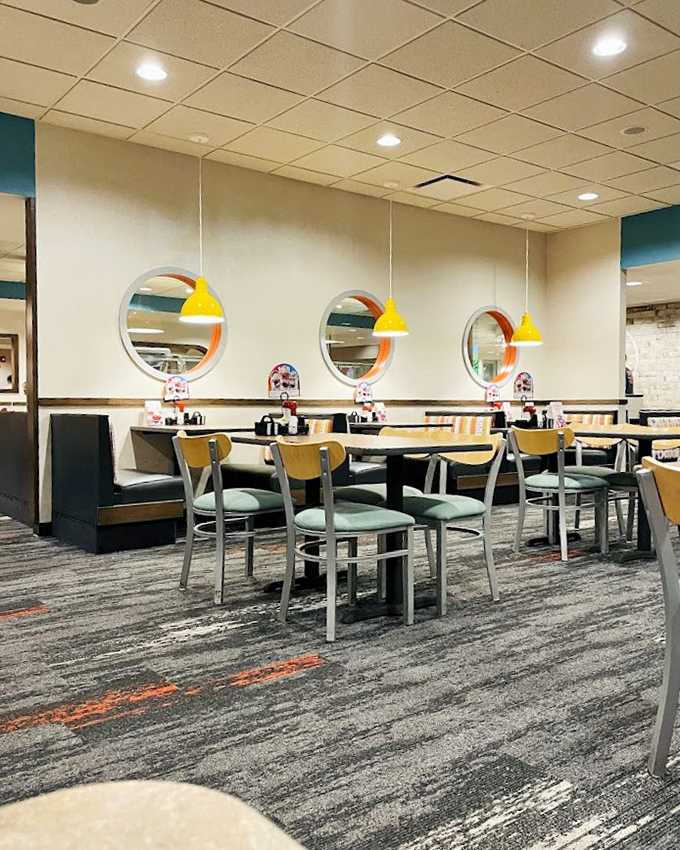 Modern touches blend with classic diner aesthetics&mdash;circular windows and yellow pendant lights create an atmosphere that says "stay awhile."