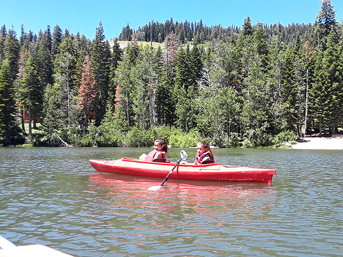 Summer's perfect pairing: a red kayak against emerald waters. These paddlers found the ultimate social distancing before it was trendy.