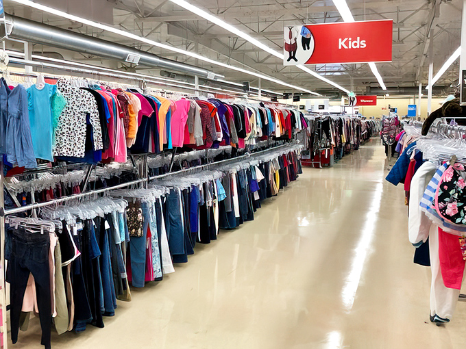 The kids' section stretches like a rainbow of tiny clothes, proof that children outgrow everything.