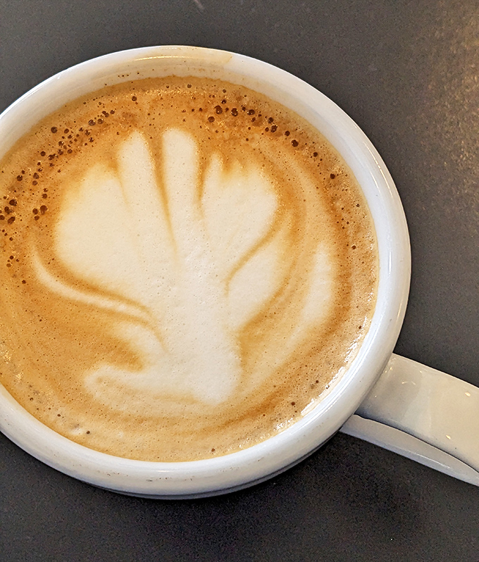 Latte art so pretty you almost don't want to drink it. Almost. The leaf design whispers, "Instagram me before the first sip."
