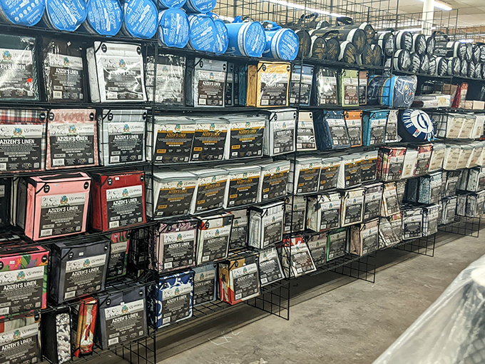 Bedding, curtains, and linens neatly packaged, waiting for their next home. That designer duvet might have cost a fortune originally&mdash;now it's yours for pocket change.