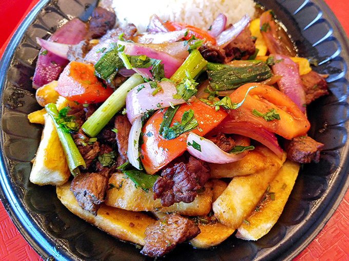 Lomo saltado: where Peruvian and Asian cuisines dance together in perfect harmony. Those french fries soaking up the sauce are having the time of their lives.