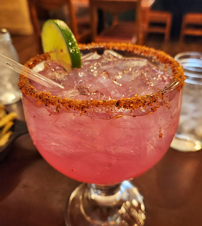 A prickly pear margarita that looks like a Sedona sunset decided to throw a party in your glass.