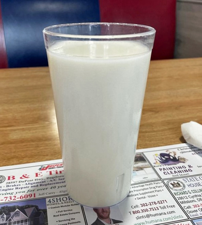 A glass of cold milk sitting on a placemat of local ads&mdash;sometimes the simplest pleasures are the ones that transport us back to simpler times.