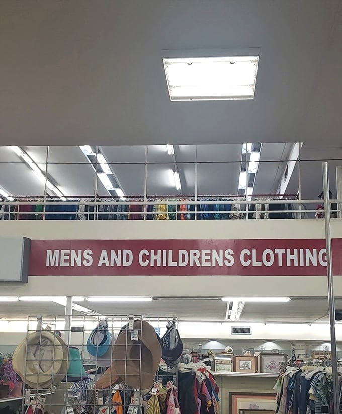 The "MENS AND CHILDRENS CLOTHING" sign serves as a North Star for navigating this vast landscape of secondhand possibilities.