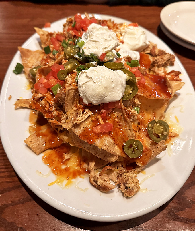 Nachos that understand the importance of proper topping distribution. Every chip deserves its moment of glory under that blanket of cheese and pulled meat.