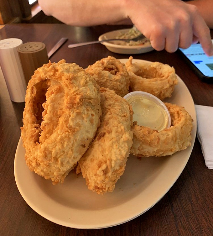 These aren't just onion rings&mdash;they're golden halos of happiness served with a side of liquid sunshine for dipping.