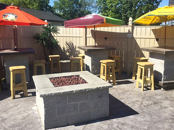 The outdoor patio where summer evenings stretch into night. Those yellow stools have witnessed countless "just one more beer" promises that nobody kept.