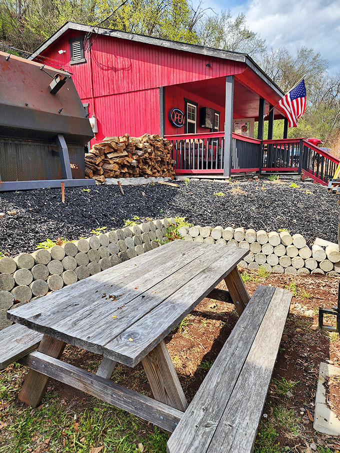 Picnic tables that have witnessed countless BBQ epiphanies. Under the watchful eye of Old Glory, this outdoor seating area invites you to commune with nature and smoked meat.
