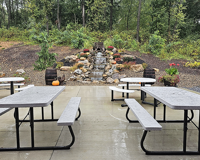 Outdoor dining with a view of a charming stone waterfall. Nature and nurture combine in this peaceful patio space perfect for savoring both food and scenery.