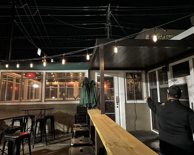 The outdoor seating area, where string lights create the perfect ambiance for enjoying Raleigh evenings and exceptional burgers.