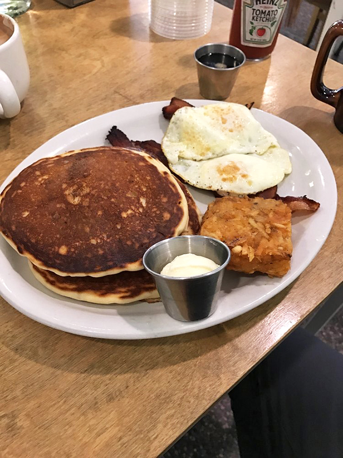 Pancakes so fluffy they could float away if not anchored by that perfect egg and crispy bacon.