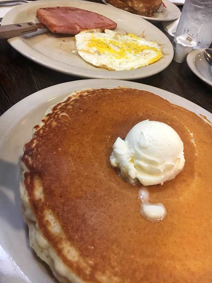 This isn't just a pancake&mdash;it's a golden-brown canvas of possibility, topped with a melting scoop of butter that's creating its own little syrup river.