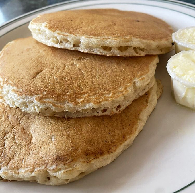 Pancakes stacked like golden discs of morning sunshine. Fluffy enough to use as pillows, if you weren't too busy devouring them with maple-soaked enthusiasm.