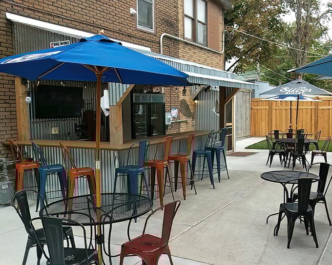 Modern industrial meets backyard comfort on this patio. Those blue umbrellas have sheltered more meaningful conversations than many therapists' offices.