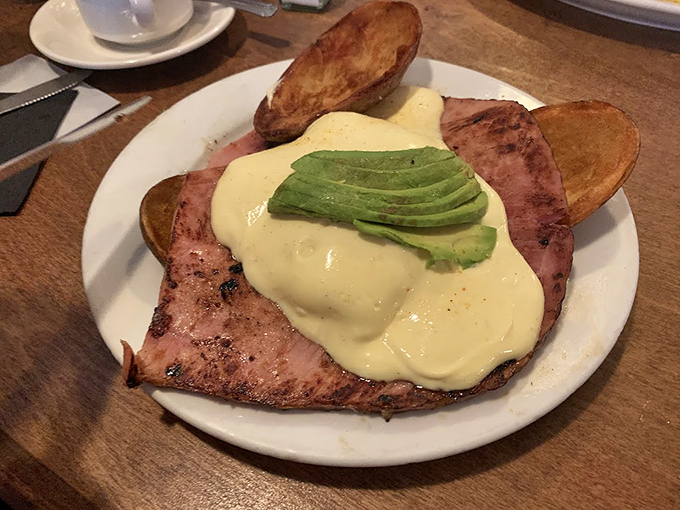 Ham Benedict with avocado: where breakfast meets California. This plate doesn't just say good morning&mdash;it shouts it with a megaphone.