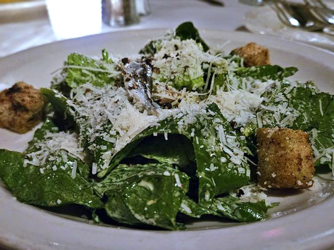 Even the salad makes a statement here—crisp greens, savory croutons, and a shower of Parmesan that transforms "eating your vegetables" from chore to pleasure.