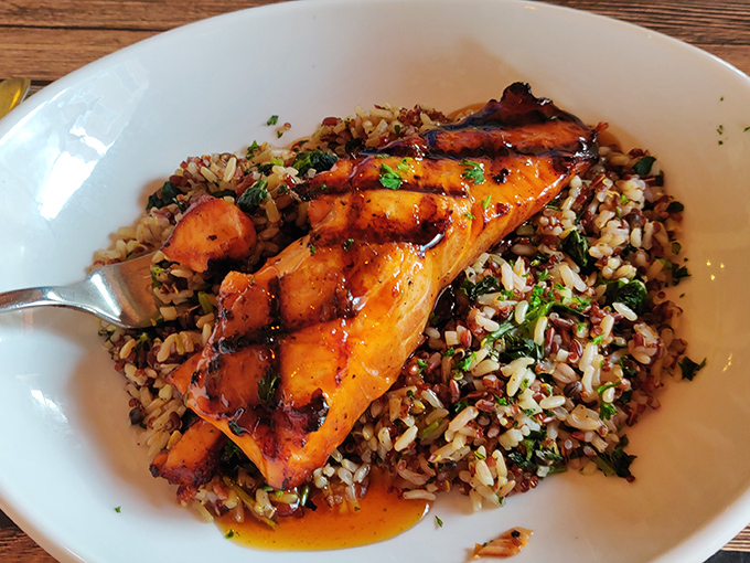 Salmon that looks like it just had a spa day, perched atop a colorful rice medley. Healthy eating never looked so indulgent.