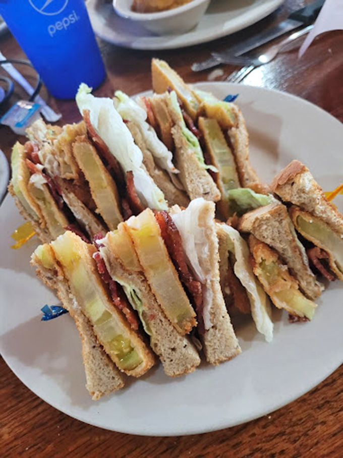 A club sandwich stacked higher than Florida's summer humidity, with layers that tell a story of perfect balance.
