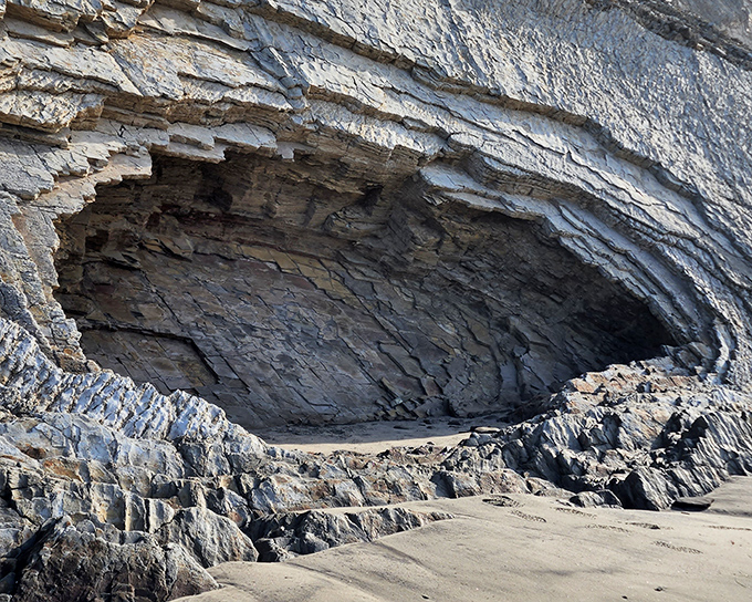 Mother Nature's answer to the man cave: a dramatic sea cave sculpted by millennia of waves that couldn't take "no" for an answer.