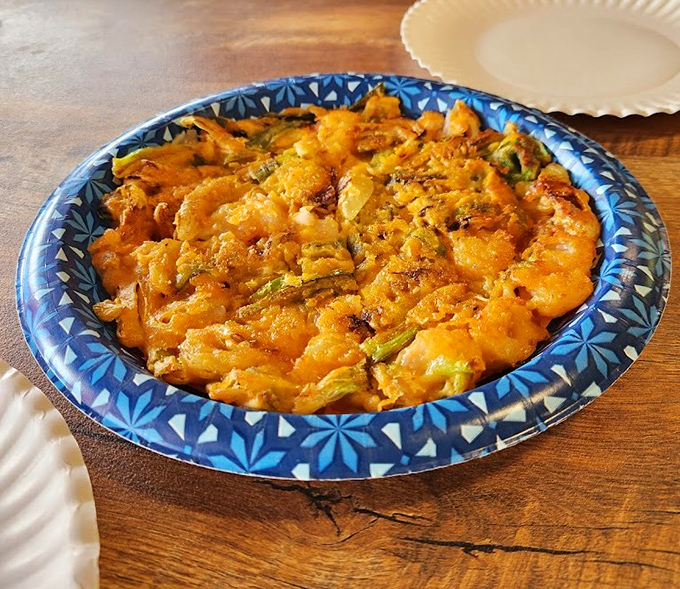 This golden seafood pancake delivers crispy edges and tender centers in every single satisfying bite.