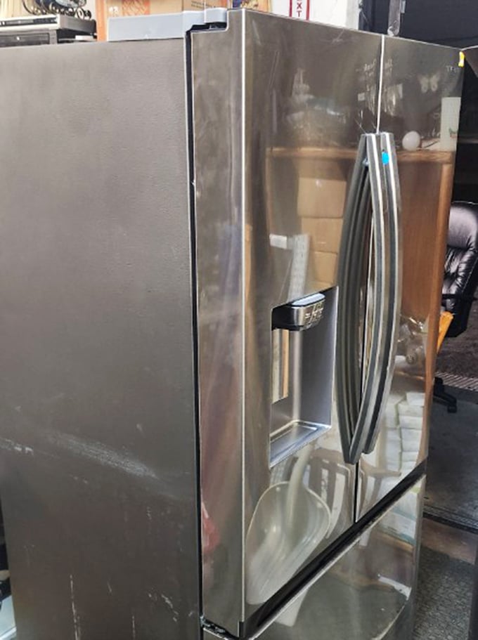 This stainless steel refrigerator has kept its cool through countless kitchen dramas and midnight snack raids. Ready for its next family's food storage saga.
