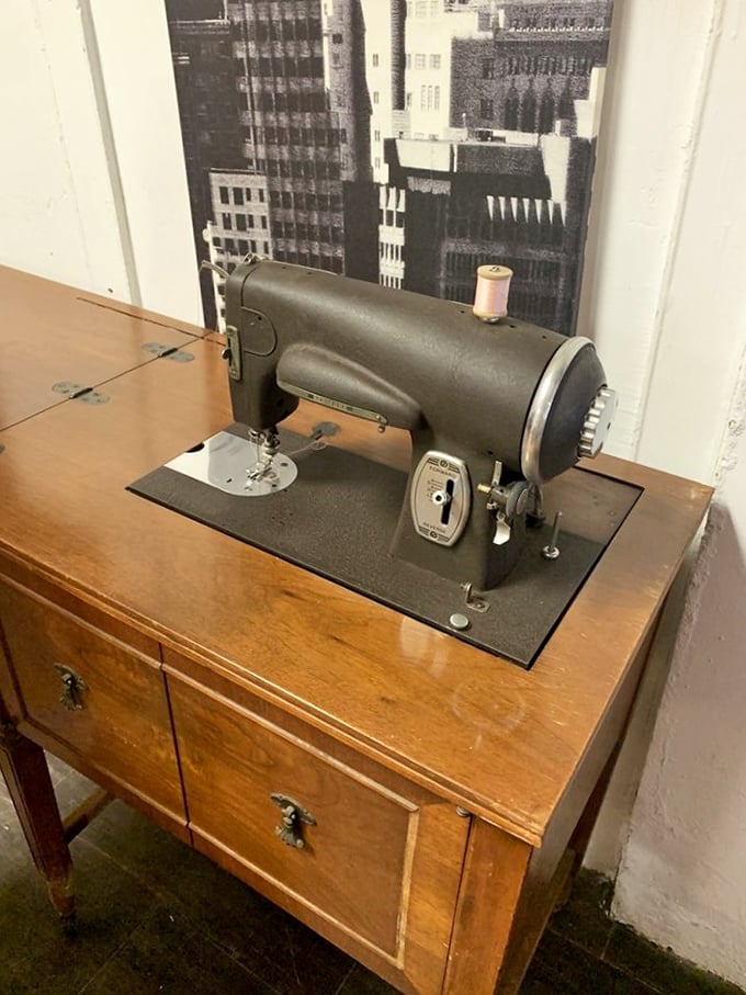 This vintage sewing machine tells stories of garments past. Sitting atop its original wooden cabinet, it's both functional history and conversation-starting decor.