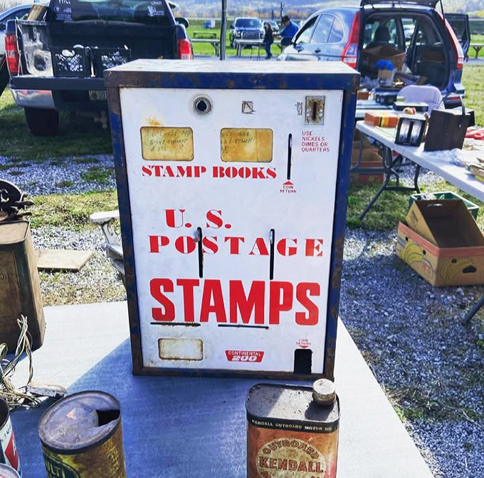 This vintage stamp machine stands as a relic from when mail required licking something, not just clicking something &ndash; nostalgia with a side of utility.