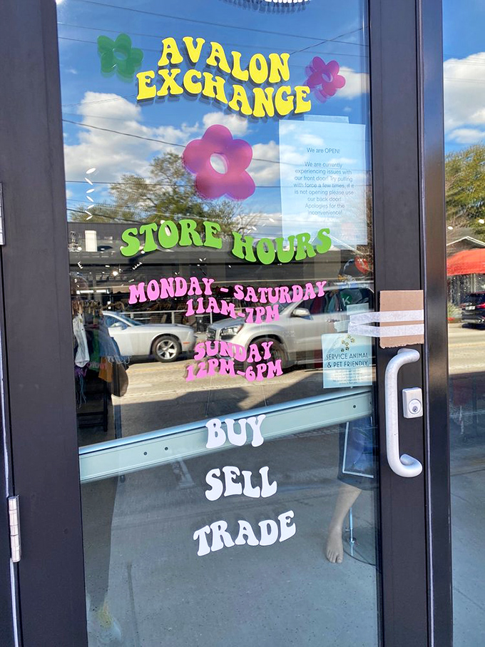 The colorful door sign reveals the magic hours when fashion treasure hunting is permitted. Note the pet-friendly policy&mdash;style knows no species!