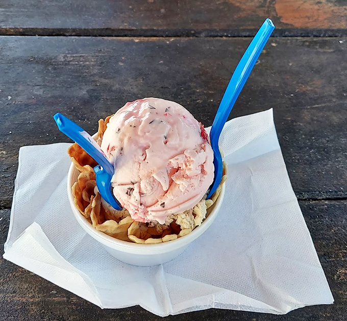 Pink ice cream with a pink spoon on a pink table&mdash;Super Scoops commits to its aesthetic with the same dedication they bring to their strawberry flavor.