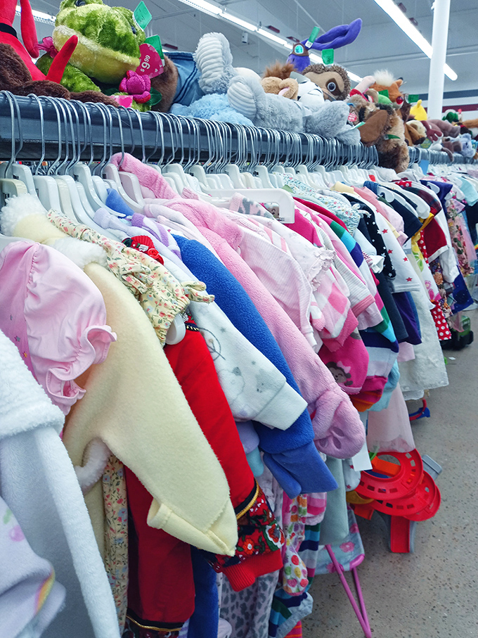 Tiny clothes for tiny humans, topped with stuffed animals standing guard like fuzzy sentinels of cuteness.